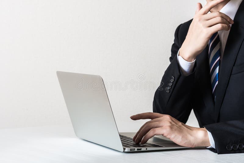 A Man in a Suit Watching a PC Stock Image - Image of estate, business ...