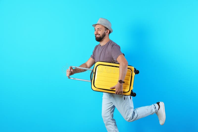 Man with Suitcase Running on Color Background Stock Image - Image of ...