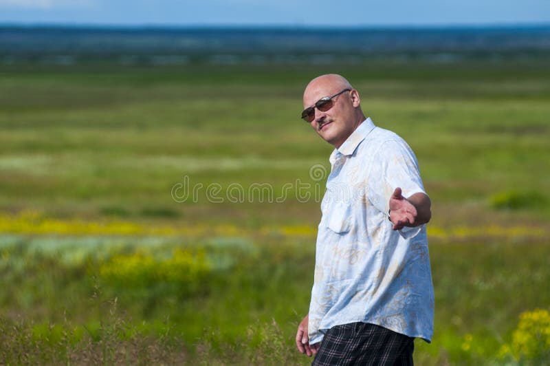 Man in Sunglasses with Friendly Face Inviting Gesture on Field ...