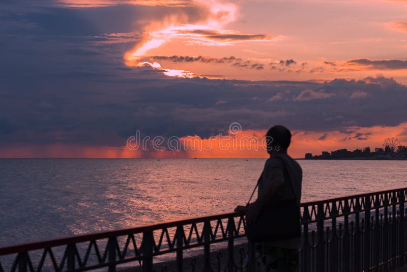 Man at sunset on the sea stock image. Image of holiday - 128230017