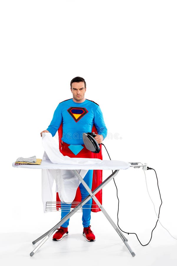 Man in Superhero Costume Ironing Clothes and Looking at Camera Stock ...