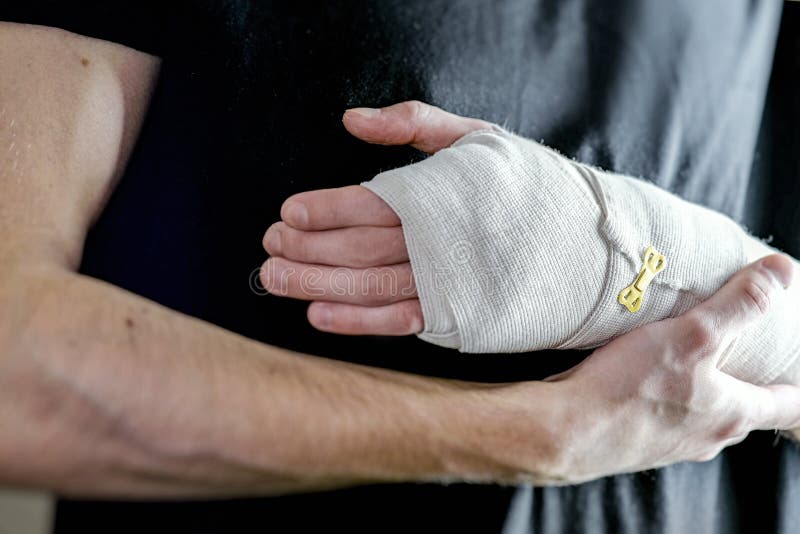 The Man Supports the Injured Hand. Primary Care, the Hand is Tightly ...
