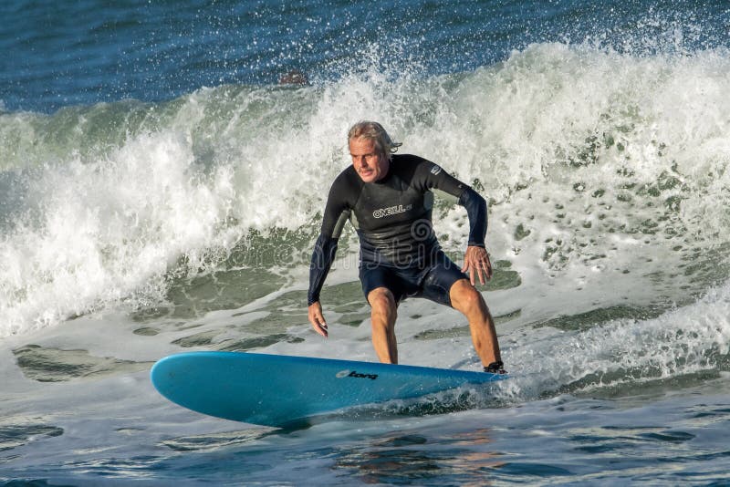 Man Surfing on a Blue Surfboard Editorial Photography - Image of ocean ...