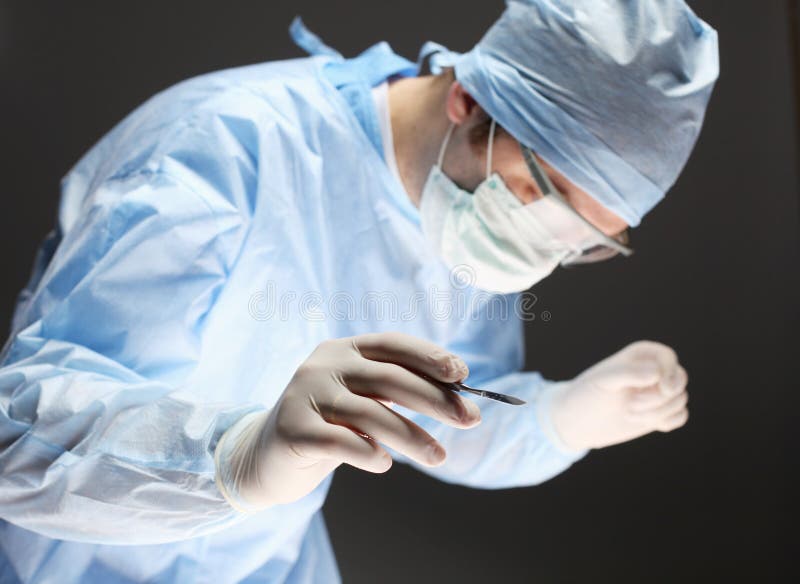 Man Surgeon Holds a Scalpel in an Operating Room Stock Photo - Image of ...
