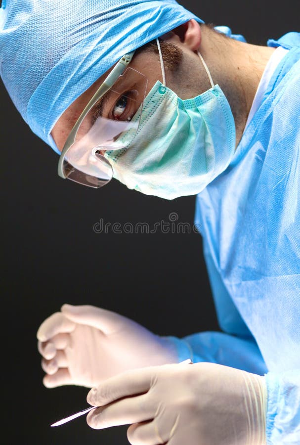 Man Surgeon Holds a Scalpel in an Operating Room Stock Image - Image of ...