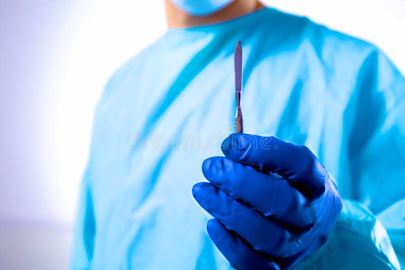 Man Surgeon Holds a Scalpel in an Operating Room Stock Image - Image of ...