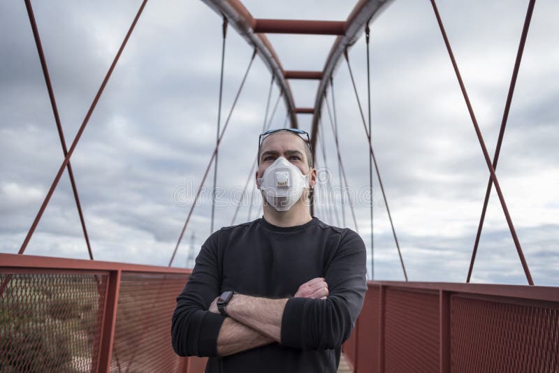 Man with Surgery Mask Looking at Camera in Pedestrian Bridge Stock ...