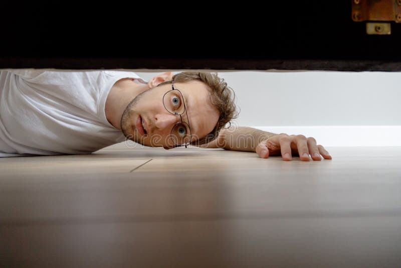 Man with Surprisingly Looking Under the Bed Stock Image - Image of face ...
