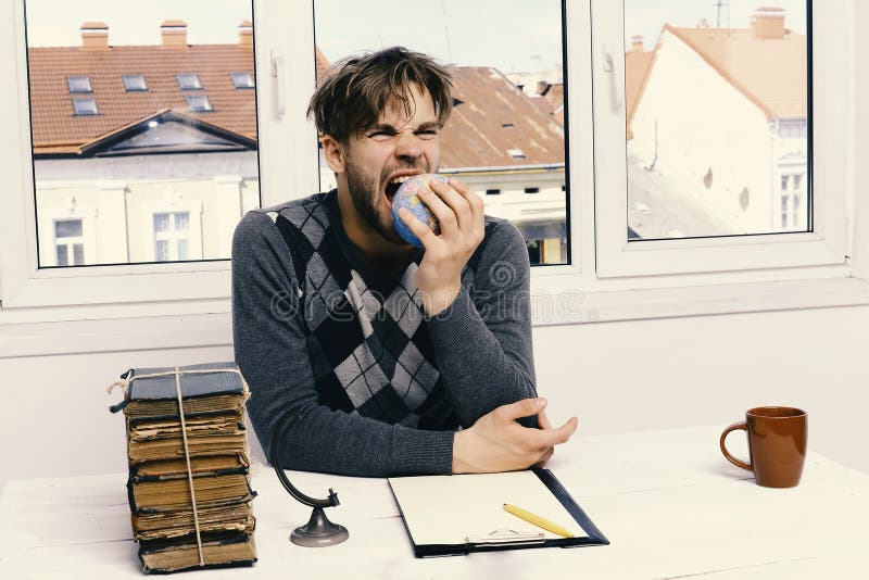Man in Sweater Sitting at Desk with Stack of Books Stock Image - Image ...