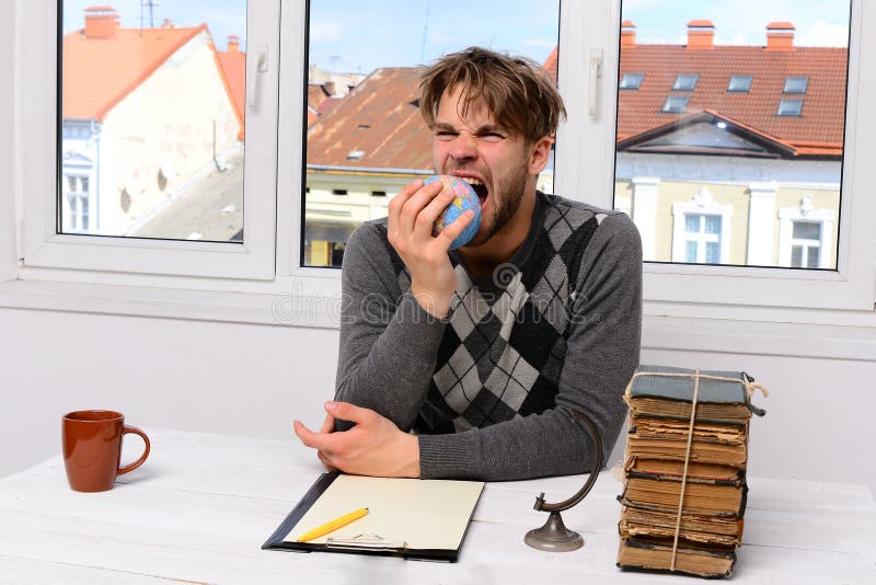 Man in Sweater Sitting at Desk with Stack of Books Stock Image - Image ...