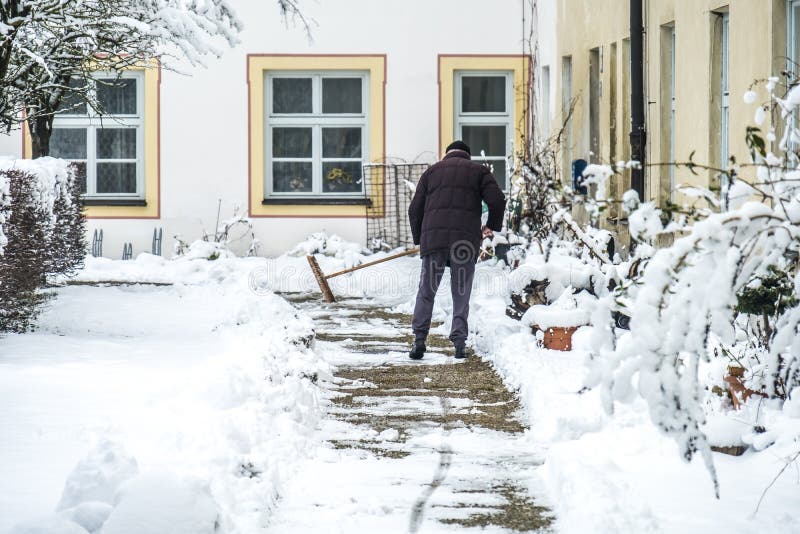 Man Sweeping Snow from the Pavement Stock Photo - Image of seasonal ...