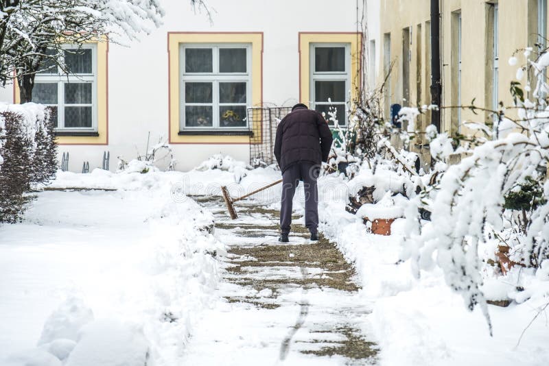 Man Sweeping Snow from the Pavement Stock Photo - Image of plow, remove ...