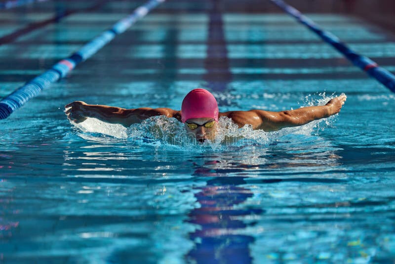 Man, Swimmer in Pink Cap and Goggles Powers through Water with ...