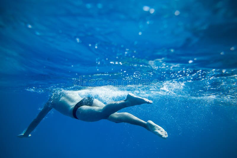 Man Swimming in the Deep Blue Sea Stock Photo - Image of sport, splash ...