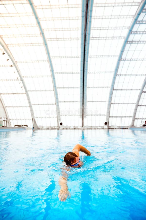Man Swimming in an Indoor Swimming Pool. Stock Image - Image of pool ...