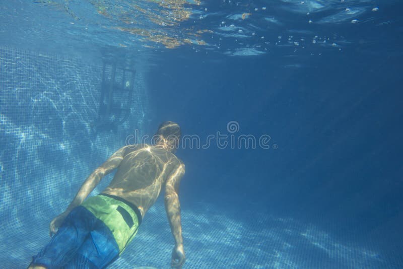 Man swimming underwater stock photo. Image of summer - 98681548