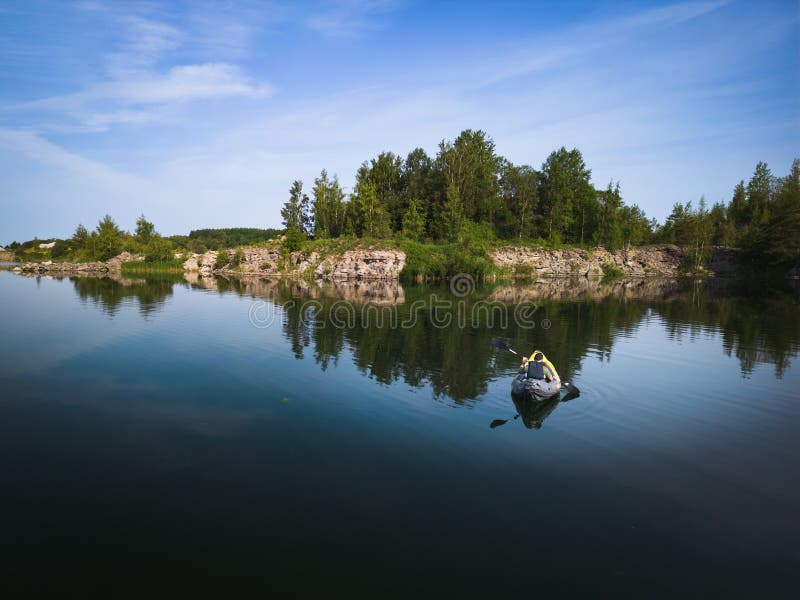 A Man Swims on a Rubber Kayak on a Lake, in the Summer, Photo from a ... A Man Swims on a Rubber Kayak on a Lake, in the Summer, Photo from a ...