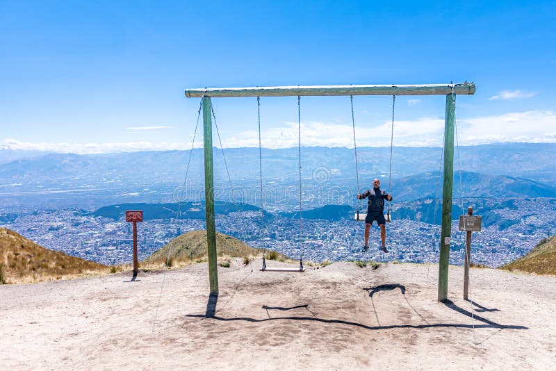 Man on a Swing at a Viewpoint in the Mountains Stock Photo - Image of ...