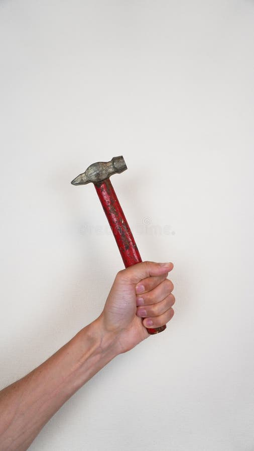 The Man Swings Holding a Red Hammer in His Hand on a Light Background ...