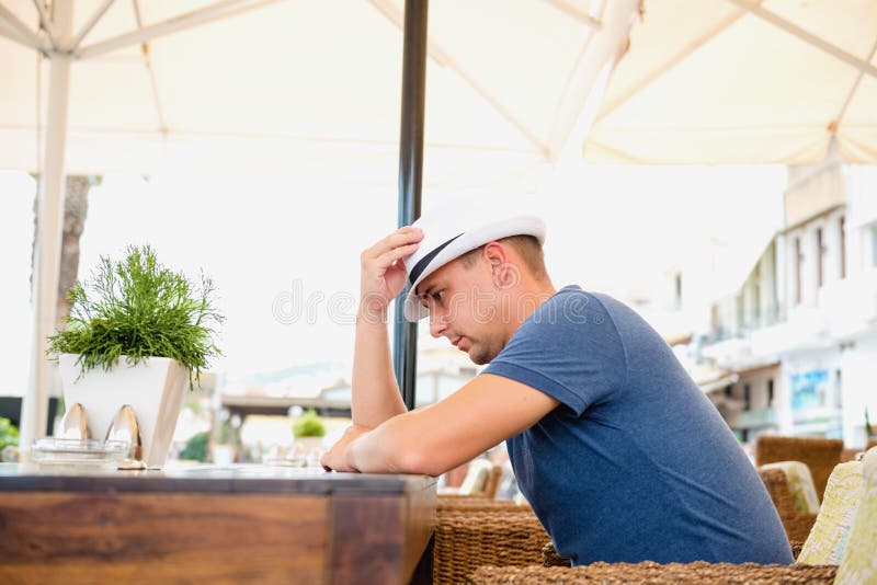 Man at a table in a cafe stock image. Image of beautiful - 53275437