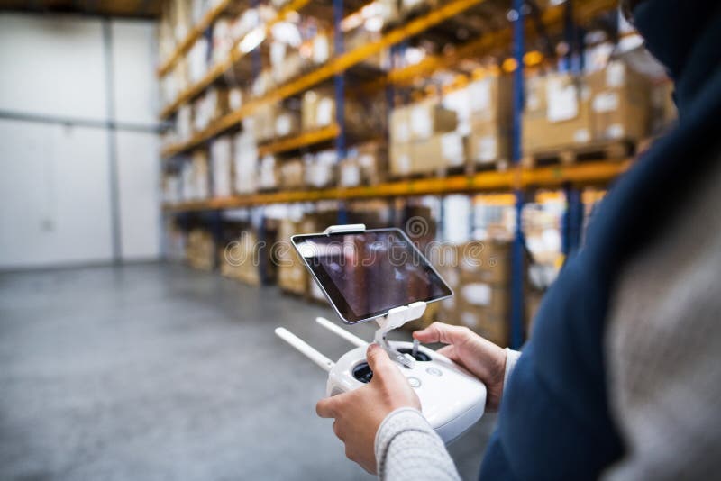 Man with Tablet and Drone Controller in a Warehouse. Stock Image ...