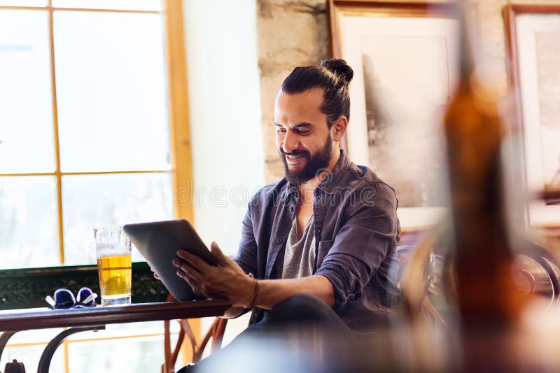 Man with Tablet Pc Drinking Beer at Bar or Pub Stock Photo - Image of ...