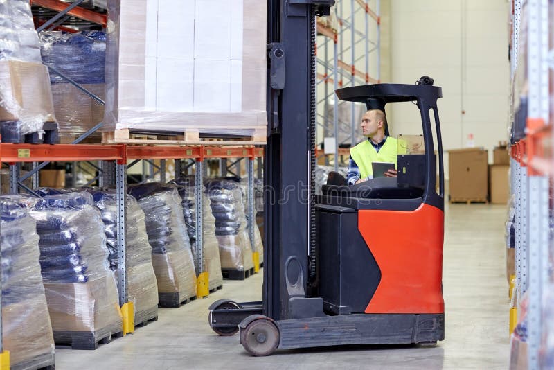 Man with Tablet Pc Operating Forklift at Warehouse Stock Image - Image ...