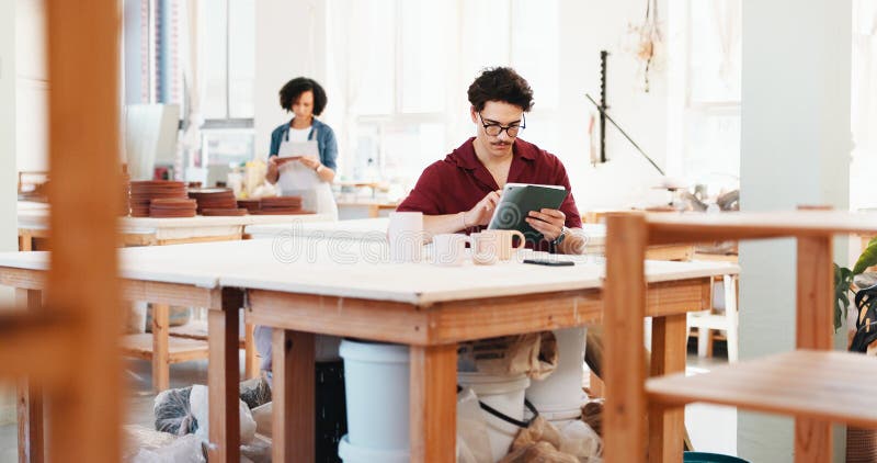 Man, Tablet and Typing at Pottery Workshop with Update for Web Store ...