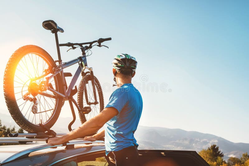 Man Take His Bicycle from Car Roof. Mountain Biking Concept Stock Photo ...