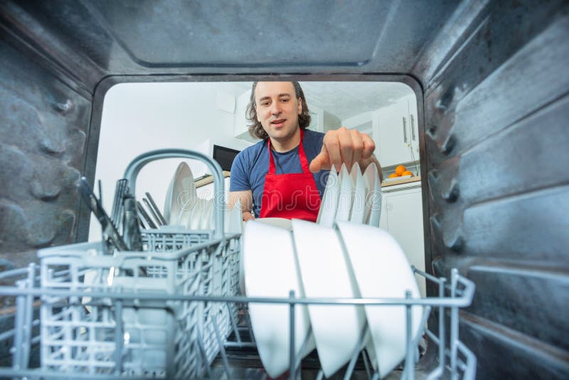 Man Take Out Plates from the Dishwasher Machine Stock Image - Image of ...