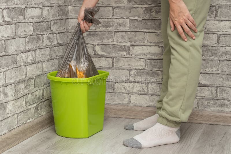 A Man Takes a Bag of Garbage Out of a Bucket Stock Photo - Image of ...