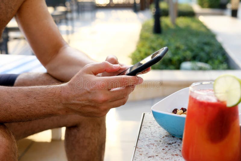 Casual Poolside Break with Smartphone and Mocktail Stock Photo - Image ...