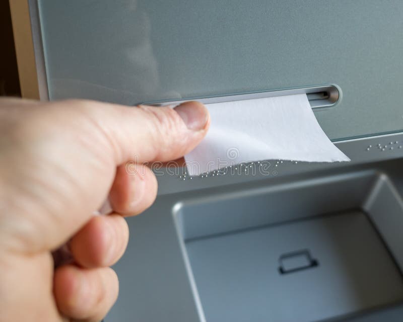 A Man Takes a Check Issued by an ATM, a Check without Inscriptions, a ...