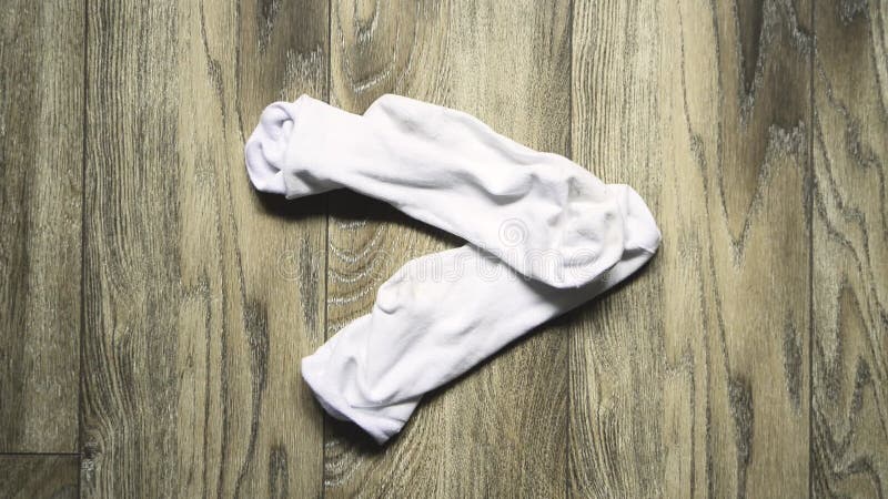 Man Takes Off His Wet Socks while Sitting on the Pier. the Man Wears a ...