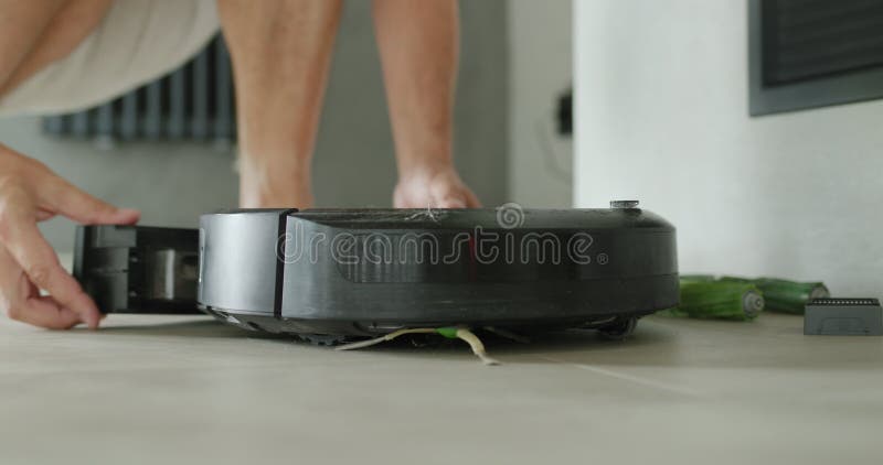 A Man Takes Out a Trash Can from a Vacuum Cleaner Robot Stock Footage ... A Man Takes Out a Trash Can from a Vacuum Cleaner Robot Stock Footage ...