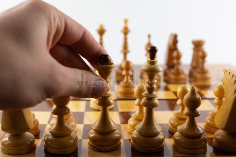 A Man Takes a Step with a Chess Piece Stock Photo - Image of king, game ...