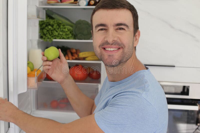 Man Taking an Apple from the Fridge Stock Photo - Image of choosing ...
