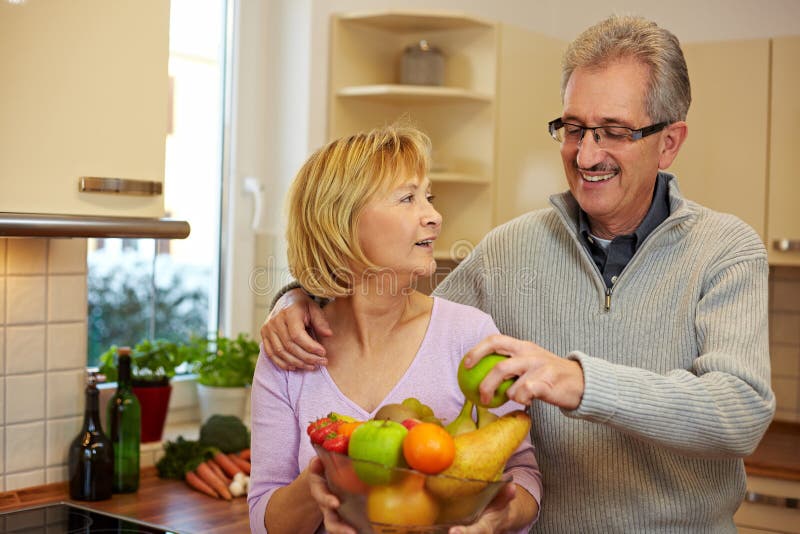 Man Taking Apple from Fruit Bowl Stock Image - Image of pensioner ...