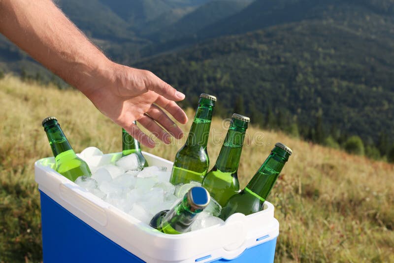 Man Taking Bottle of Beer from Cool Box in Nature, Closeup Stock Photo ...