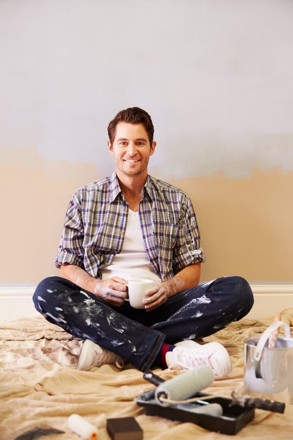 Man Taking a Break Whilst Decorating Room Stock Photo - Image of ...