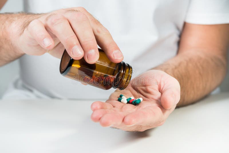 Man taking drugs stock image. Image of painkillers, bottle - 80853709