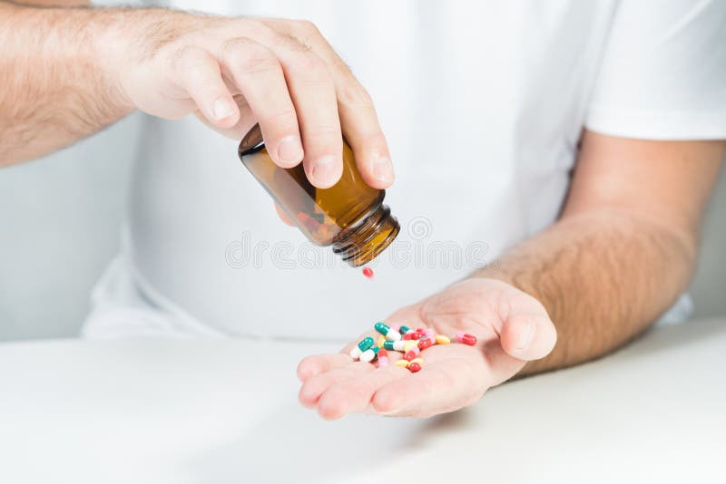 Man taking drugs stock image. Image of druggy, drug, bottle - 80854259