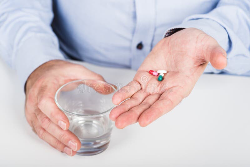 Man taking drugs stock photo. Image of medicines, bottle - 81922828