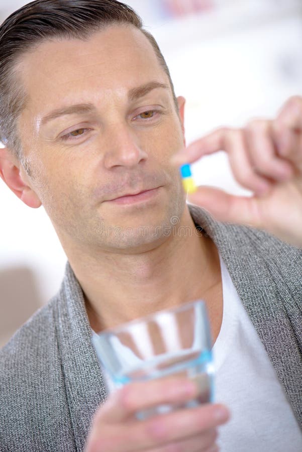 Man taking drugs stock photo. Image of lavage, adult - 313273664