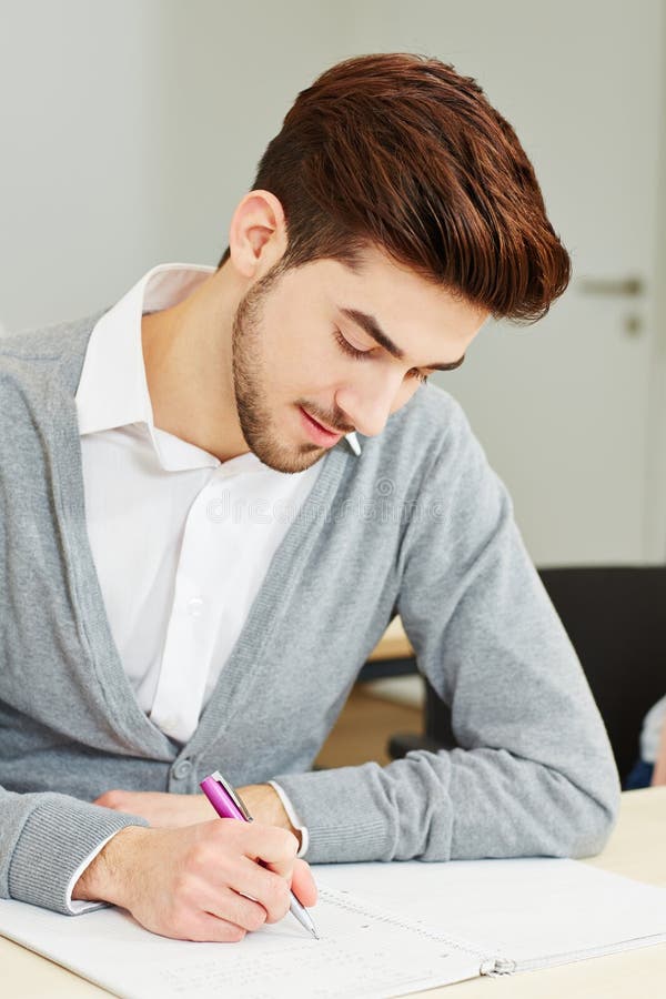Male Student Writing Notes in Classroom Stock Photo - Image of ...