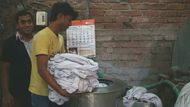 Man Taking Laundry Out of a Machine in a Laundry Manufactory in Mumbai ...