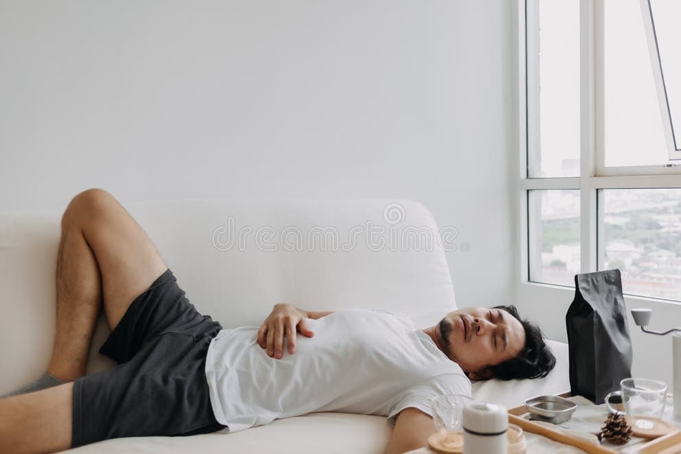 Man is Taking a Nap on the Sofa after Finish Making the Coffee. Stock ...