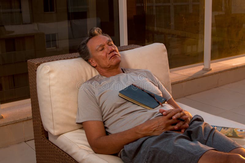Man taking a napping stock image. Image of reading, balcony - 167087579