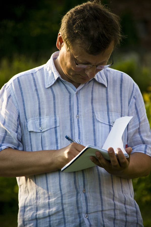 Man taking notes stock image. Image of busy, active, papers - 12371895