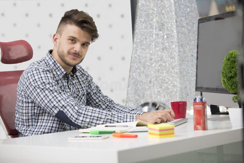 Man Taking Notes Down from His New Laptop Computer at Work in the ...